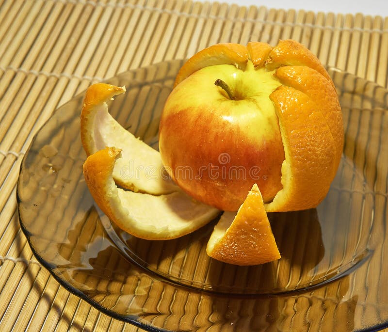 Apple in orange peel stock photo. Image of close, isolated - 69038882