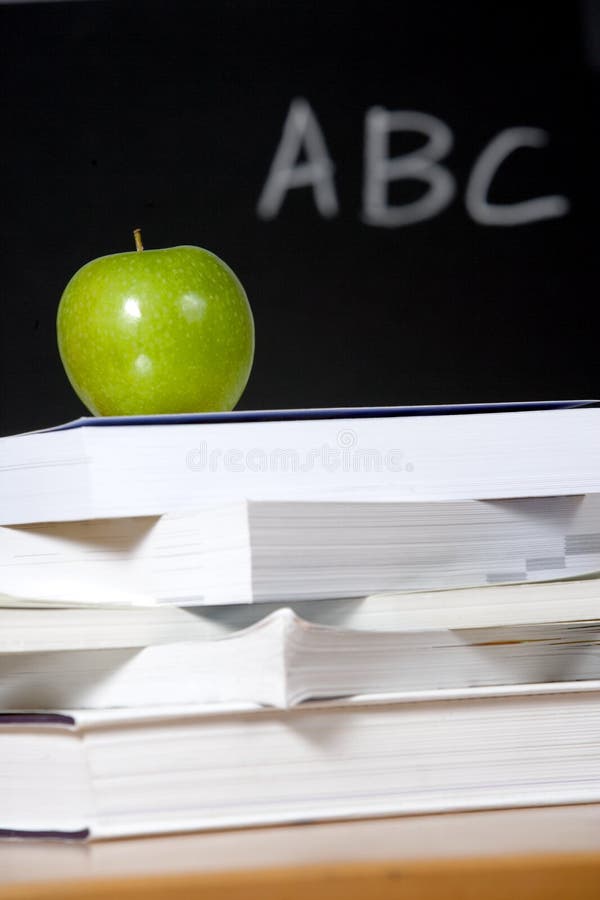 Apple on Stack of Books in Classroom Stock Photo - Image of notes ...