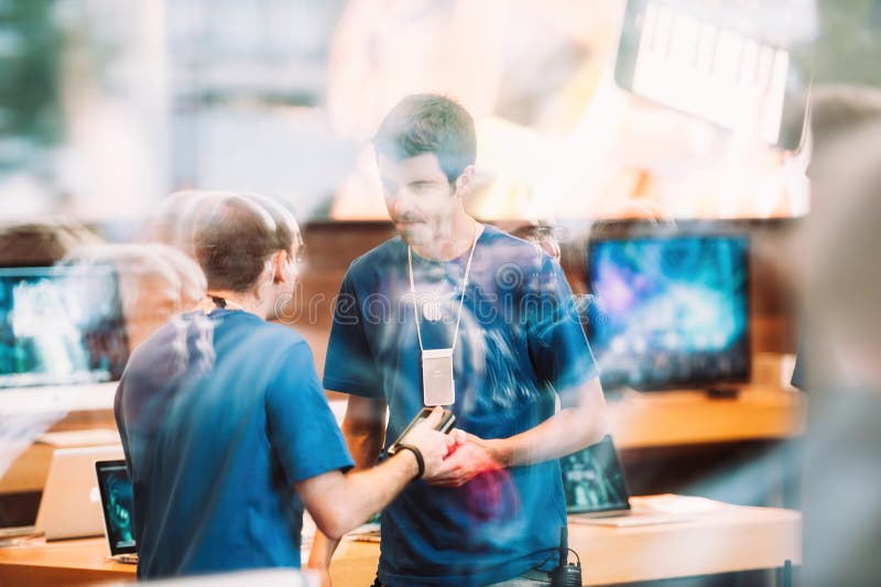 Apple Store Computers Interior Reflected with Genius Workers Talking ...