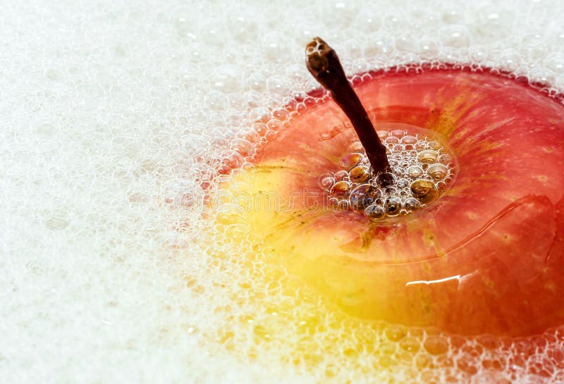 Apple in Water. the Apple is Washed and Cleaned of Dirt and Dust in a ...