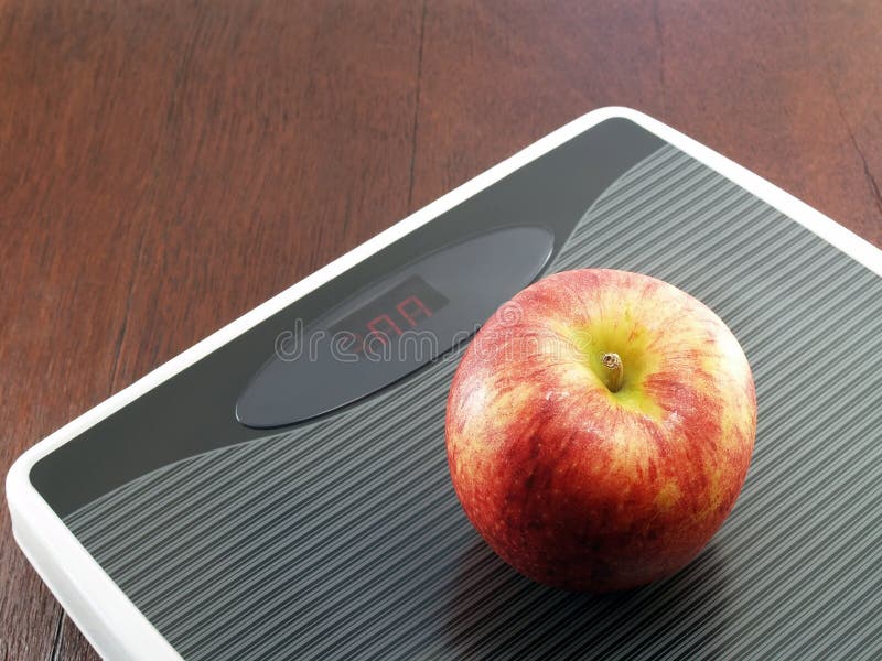 Red Apple on Grey Digital Weight Scale on Dark Brown Wooden Floor Stock ...