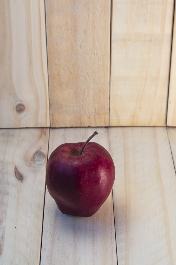 Apple on wood floor stock photo. Image of hair, background - 77206954