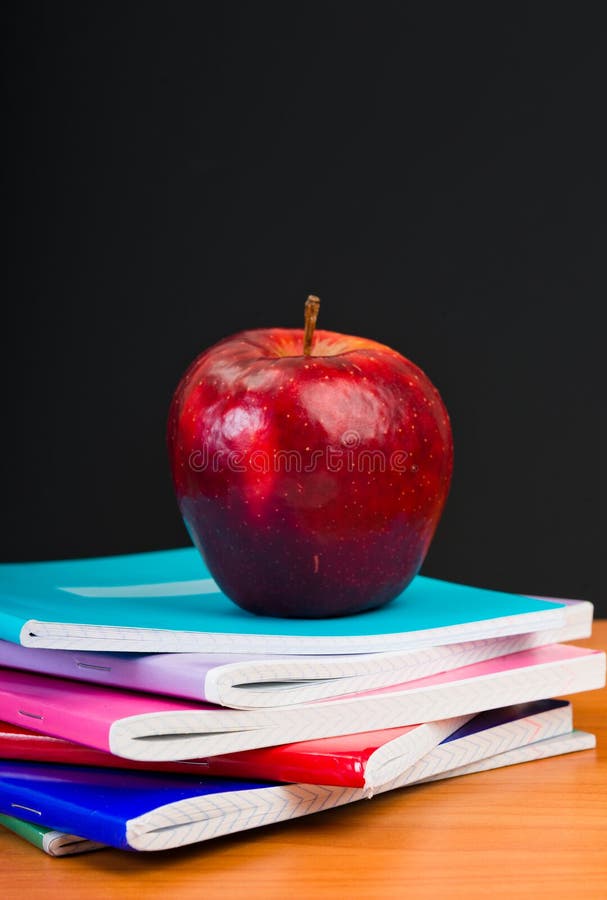 Apple on writing-books stock image. Image of back, supplies - 32921243