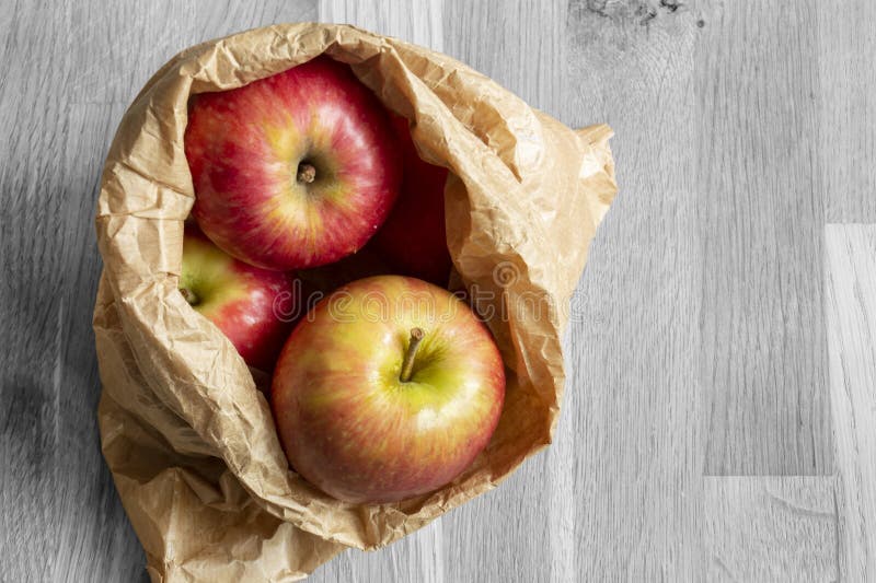 Apples in a Brown Paper Bag on a Wood Background with Selective Colour ...