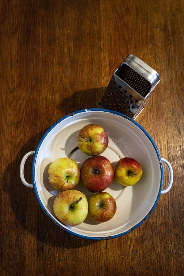 Apples next to a bowl stock photo. Image of dark, hoop - 251686486