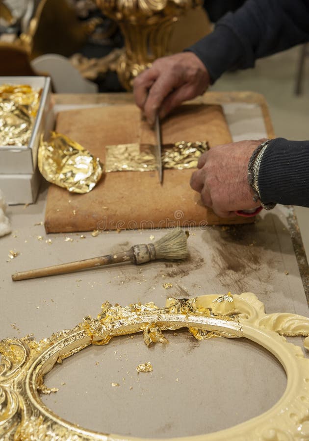 Application of Gold Leaf To a Frame. Gilding Process Technique.. Stock ...