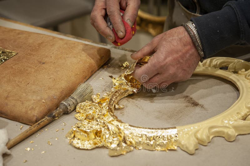 Application of Gold Leaf To a Frame. Gilding Process Technique.. Stock ...