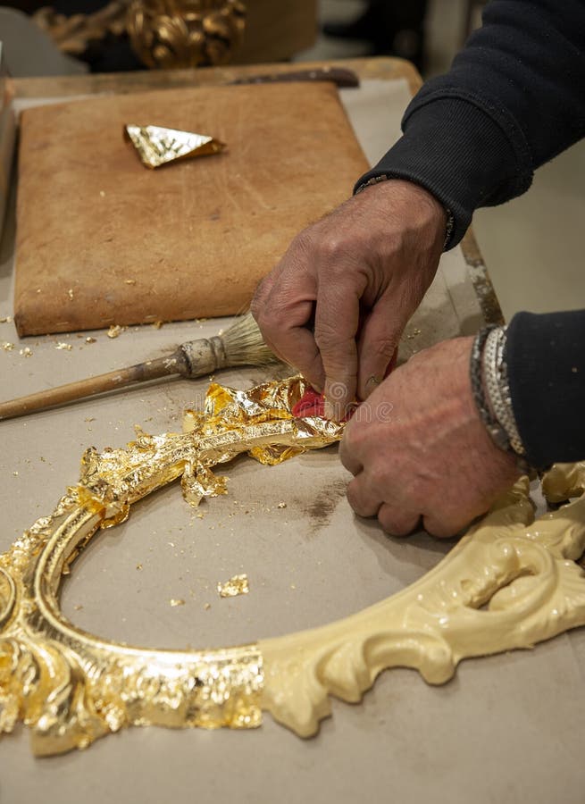 Application of Gold Leaf To a Frame. Gilding Process Technique.. Stock ...