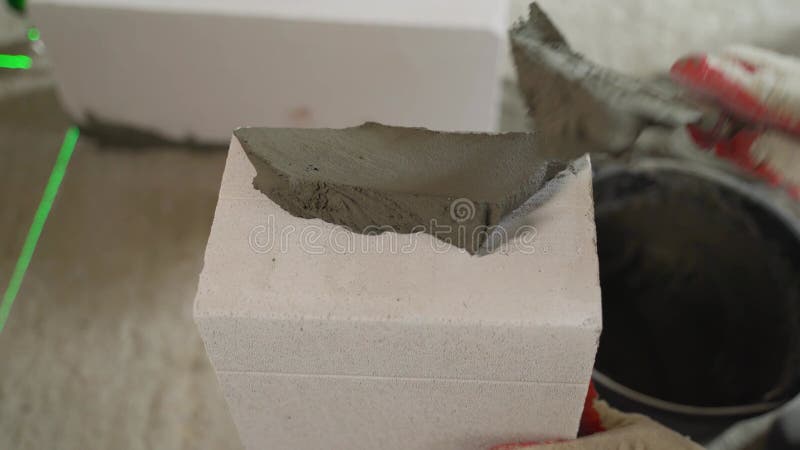 The Mortar is Applied To the Wall Masonry Block. Construction Worker ...
