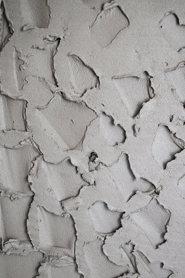 Applying Cement Plaster in a Thick Layer on a Concrete Wall by a ...