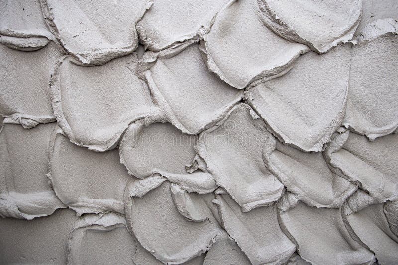 Applying Cement Plaster in a Thick Layer on a Concrete Wall by a ...