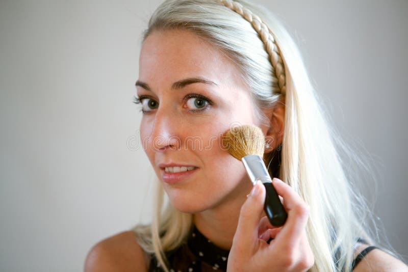 Applying face powder stock image. Image of treatment - 14727929