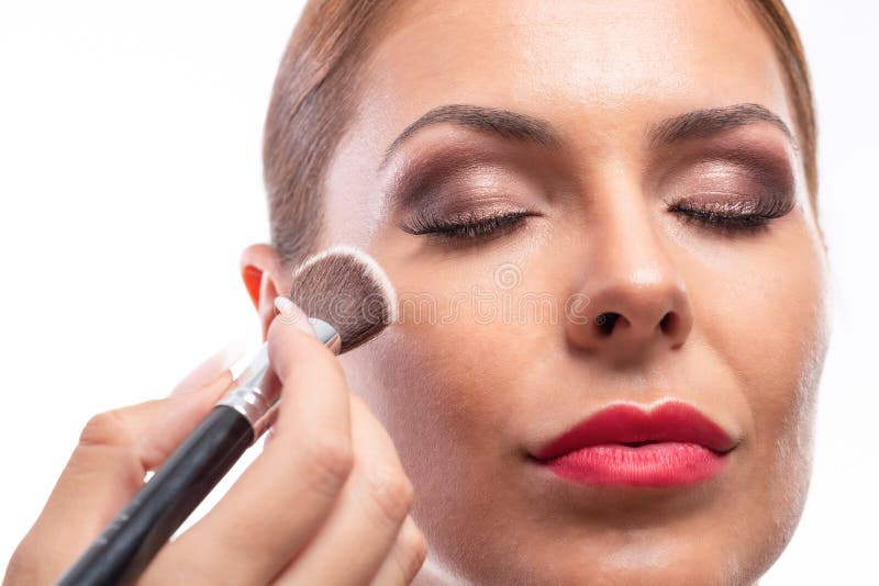 Applying Makeup on a Face of a Beautiful Woman Stock Photo - Image of ...