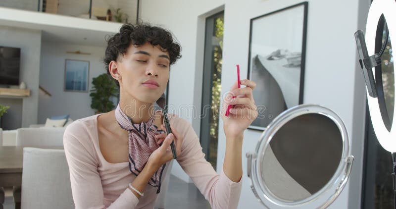 Applying Makeup, Non Binary Person Using Mirror and Phone at Home Stock ...