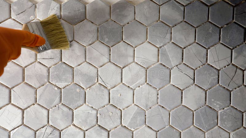 Repair Work Carried Out by a Ceramic Tile Specialist. Applying a ...