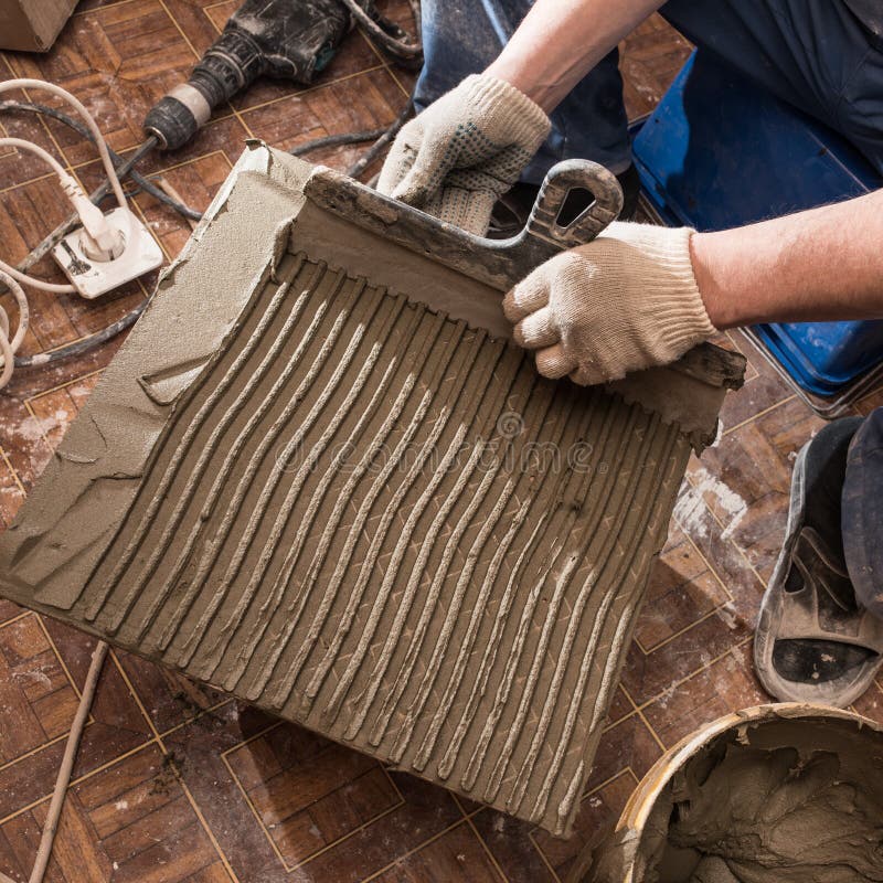 Applying a Special Solution on the Tile Laying it on the Floor O Stock ...