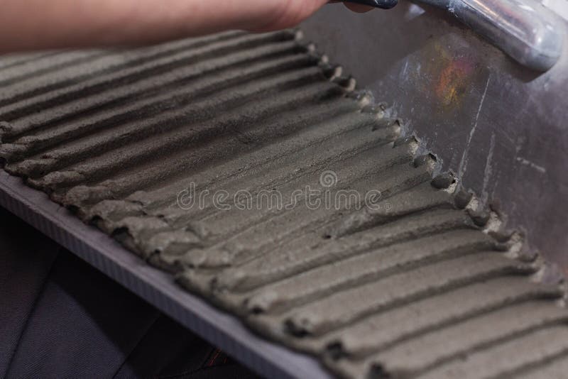 Applying Tile Adhesive on Tile Stock Photo - Image of adhesive ...