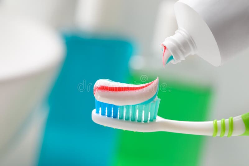 Applying Toothpaste on Brush Against Blurred Background, Closeup Stock ...