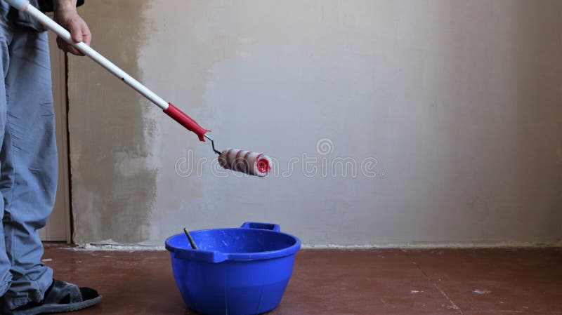 Applying Wallpaper Paste To the Wall with a Roller on a Long Handle ...