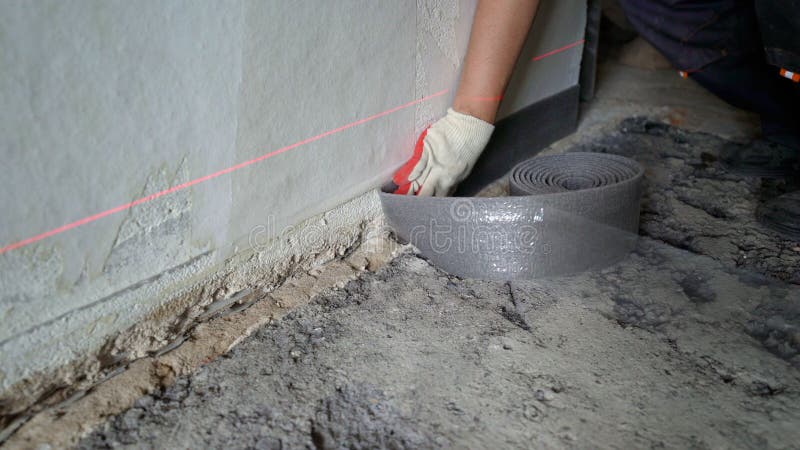 Applying a Waterproofing Tape To the Joint between the Wall and the ...