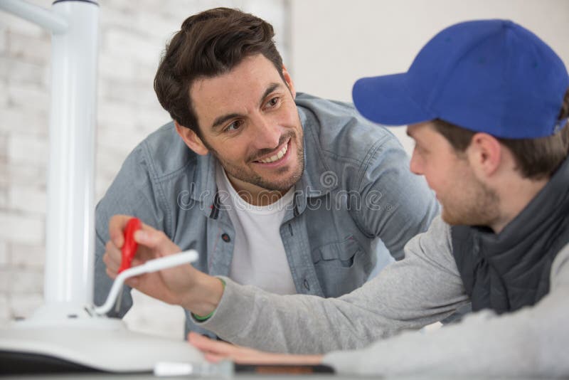 Apprentice Assembling Stool Under Supervision Stock Photo - Image of ...