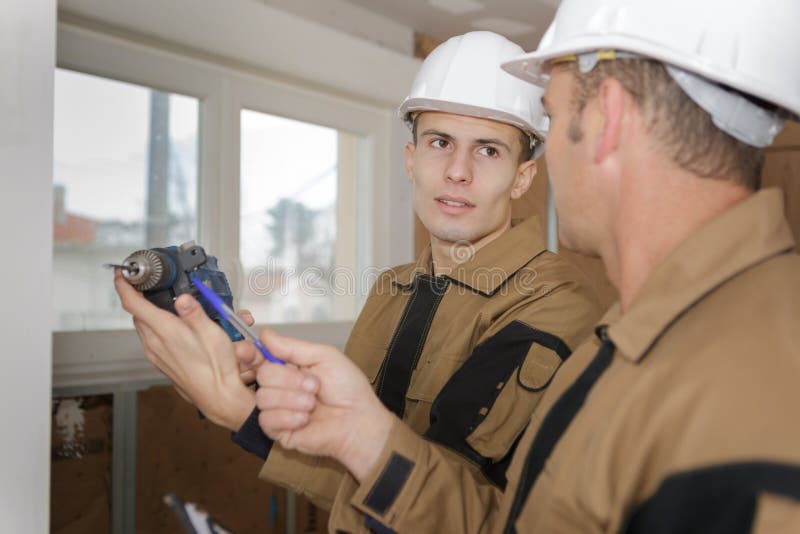 Apprentice Builder with Electric Drill Stock Photo - Image of ...