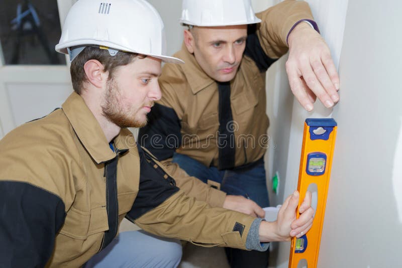 Apprentice Builder Holding Spirit Level Stock Photo - Image of ...