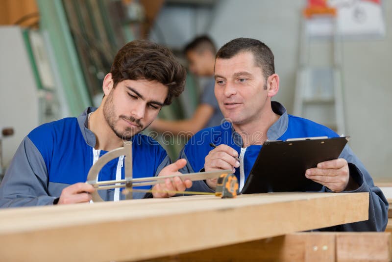 Apprentice Carpenter Preparing To Use Protractor in Woodworking Studio ...