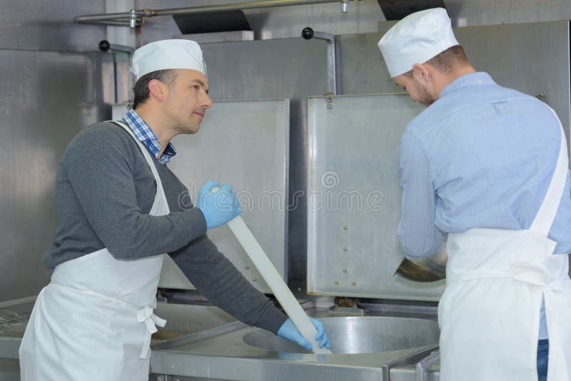 Apprentice and Chief Preparing Meat in Restaurant Kitchen Stock Photo ...