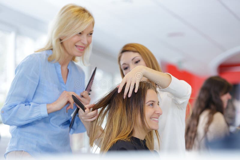Apprentice Cutting Hair while Instructor Watching Stock Photo - Image ...