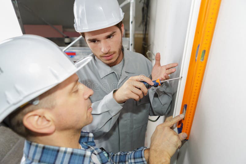 Apprentice Electrician Being Watched at Work Stock Photo - Image of ...