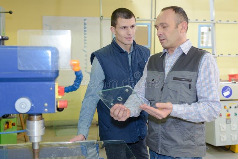 Apprentice Engineer Having Discussion in Factory Stock Image - Image of ...