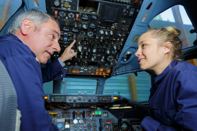 Apprentice Engineer in Stationary Aircraft Cockpit with Supervisor ...