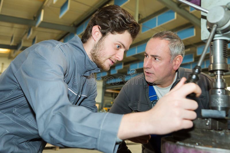 Apprentice Engineer Working on Factory Floor Stock Photo - Image of ...