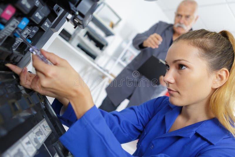 Apprentice Fixing a Machine Stock Image - Image of learning, drawings ...