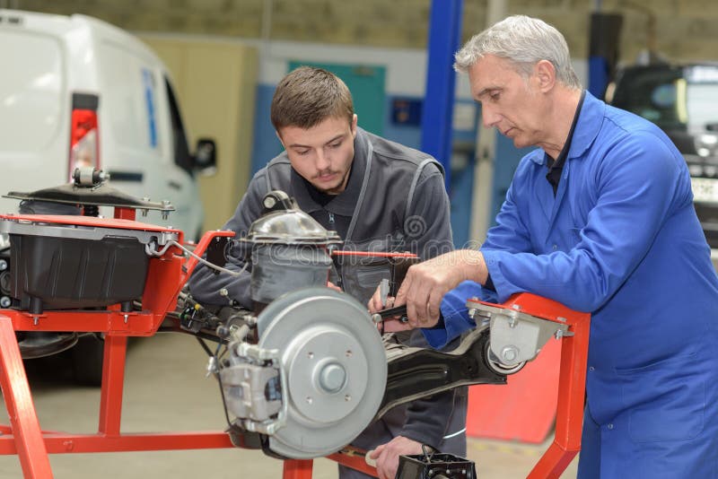 Apprentice in the garage stock image. Image of material - 118383315