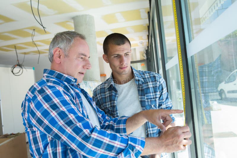 Apprentice Glazier with Instructor Installing Window at Site Stock ...
