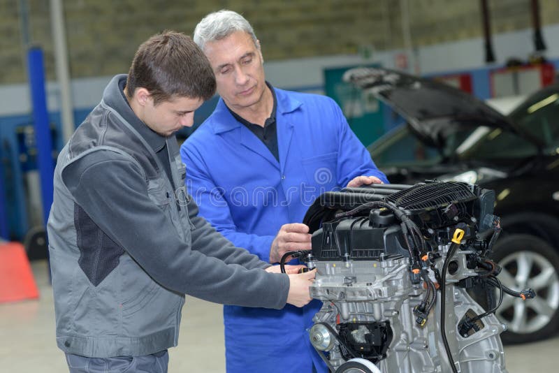 Apprentice Mechanic in Auto Shop Working on Car Engine Stock Photo ...