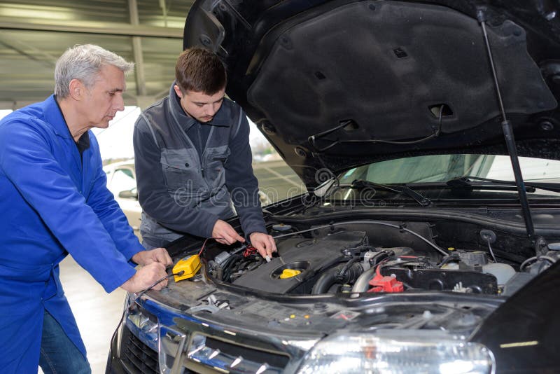 Apprentice Mechanic in Auto Shop Working on Car Engine Stock Photo ...