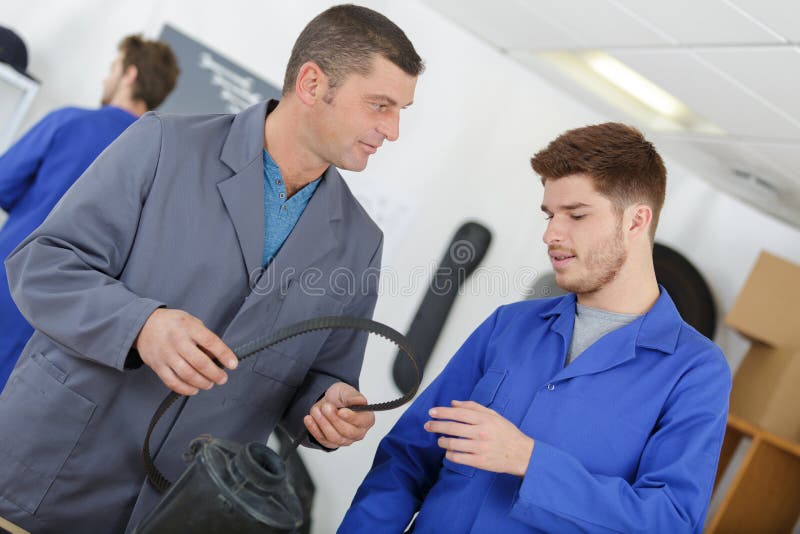 Apprentice Mechanic in Auto Shop Working on Car Part Stock Photo ...