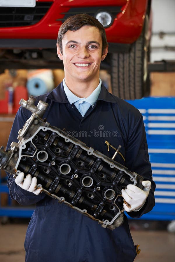 Apprentice Mechanic Holding Engine Block Stock Photo - Image of ...