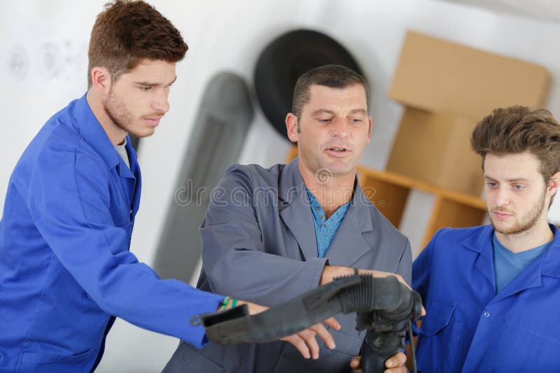 Apprentice Mechanics Working in Auto Repair Shop Stock Photo - Image of ...