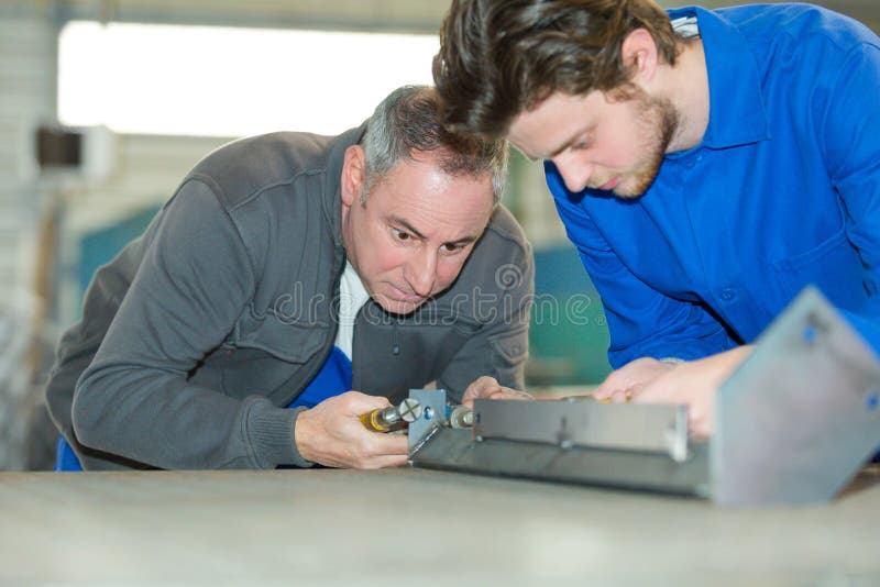 Apprentice in Metal Craft Class Stock Image - Image of mentor, boys ...