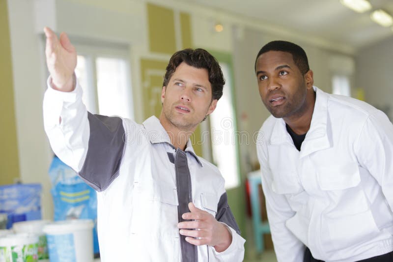 Apprentice Painter in Professional Training with Boss Stock Image ...