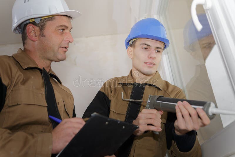 Apprentice Putting Caulking on Installed Window Stock Image - Image of ...