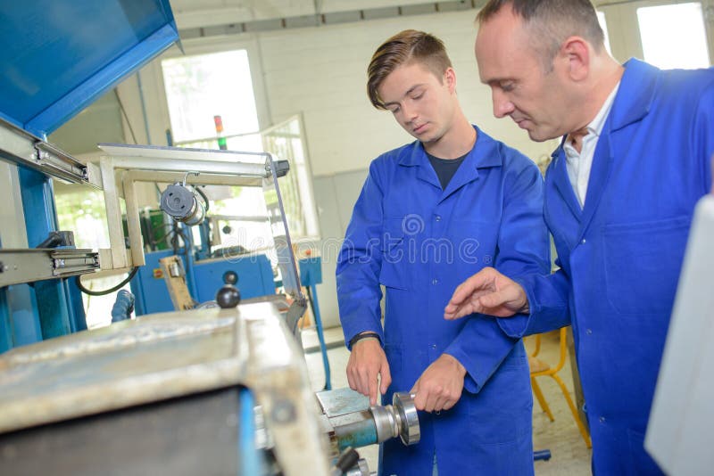 Apprentice and Instructor Build a Wooden Shelf Stock Photo - Image of ...
