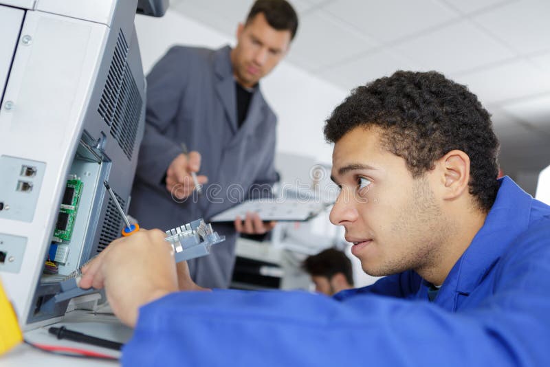 Apprentice Technician Repairing Printer at Business Place at Work Stock ...