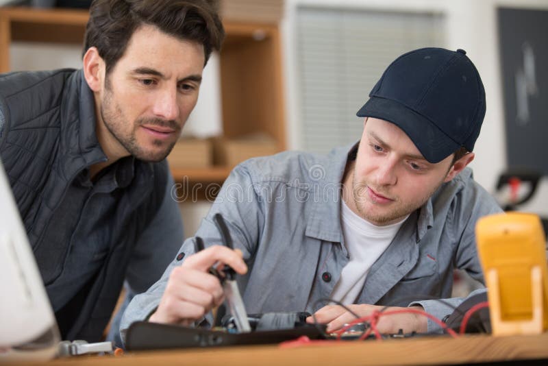 Apprentice Technician Working Under Supervision Stock Photos - Free ...