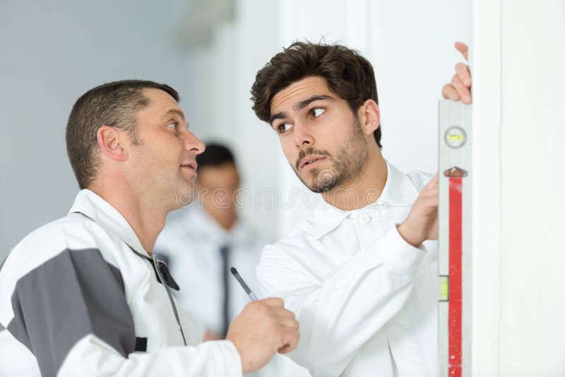 Apprentice Tradesman Learning To Use Spirit Level Stock Photo - Image ...