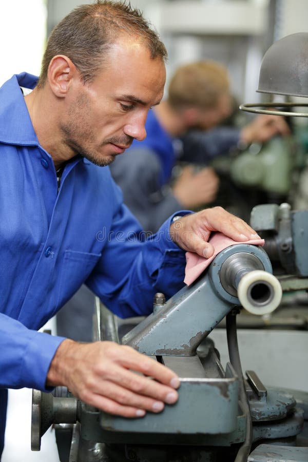 Apprentice Using Machinery in Factory Stock Image - Image of people ...
